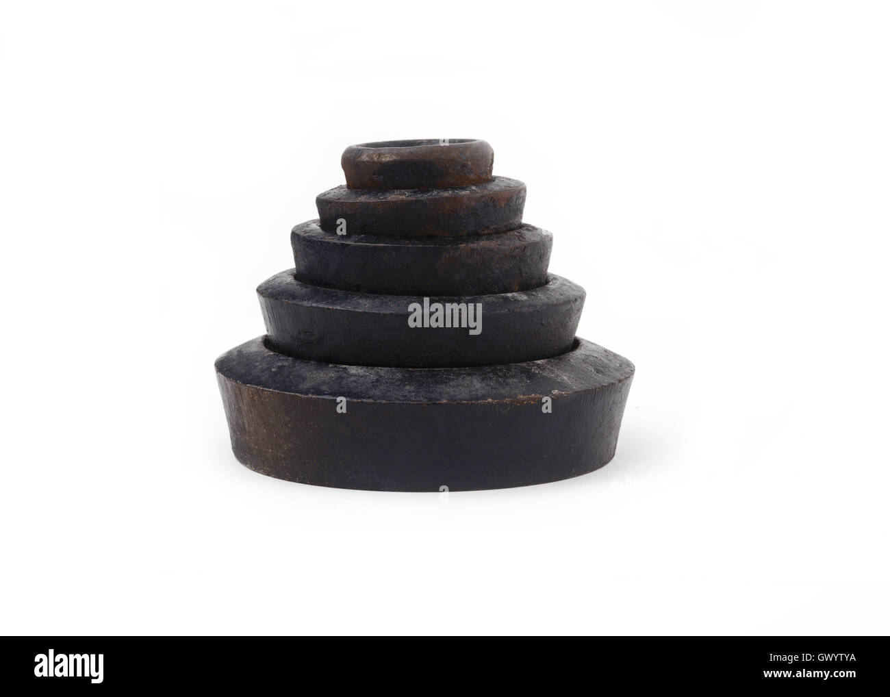 A set of old black iron rusty imperial weights isolated on a white ...