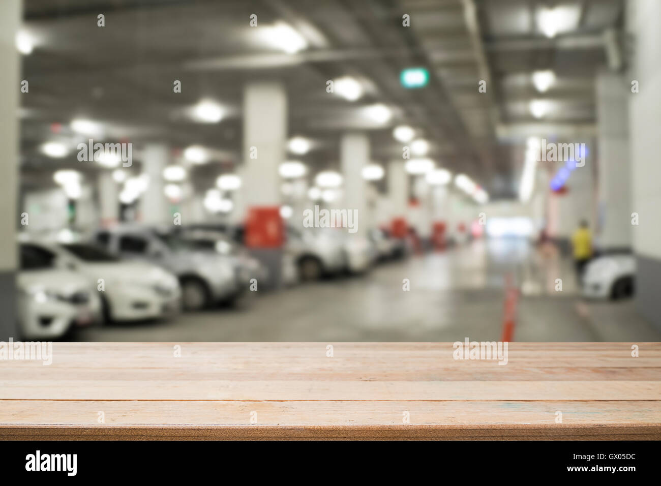 Empty wooden top table and garage blurred background. For product ...