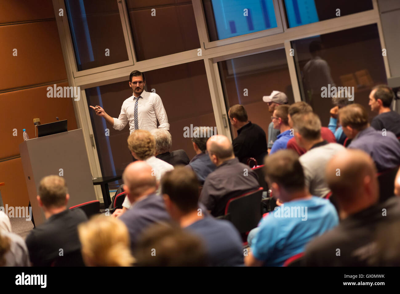Business speaker giving a talk in conference hall Stock Photo - Alamy