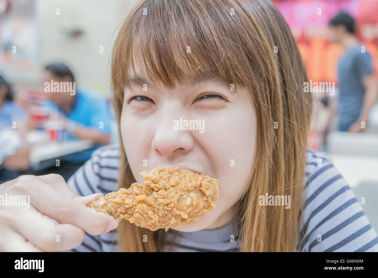 Asian woman eating fried chicken hi-res stock photography and images ...
