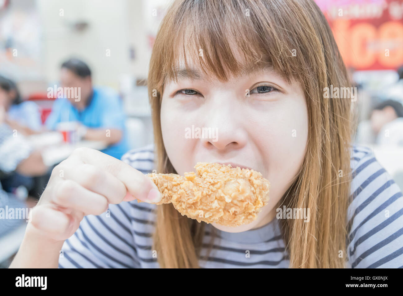 Asian woman eating fried chicken hi-res stock photography and images ...