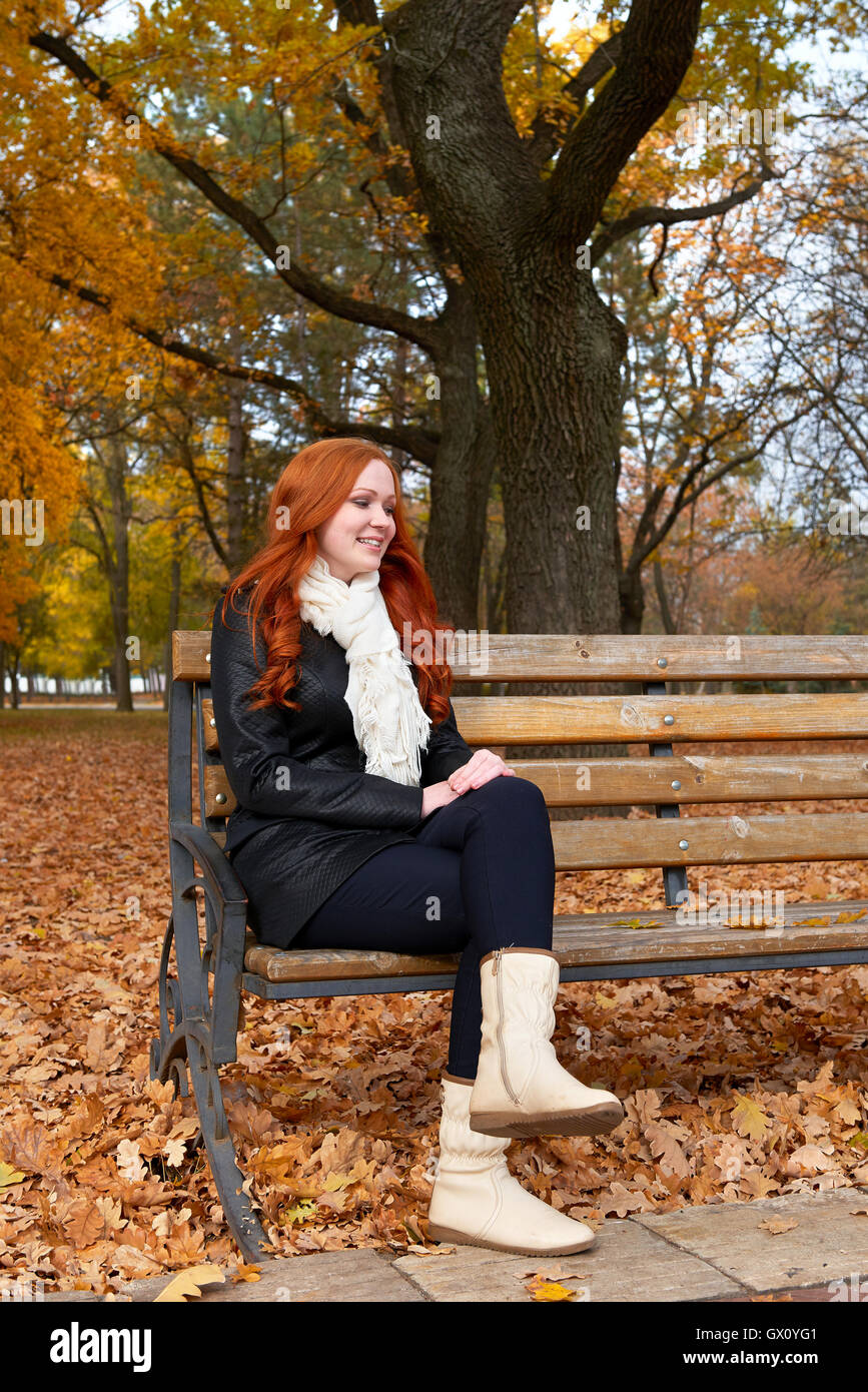 Redhead Girl In Autumn City Park Sit On Wood Bench One People At Day
