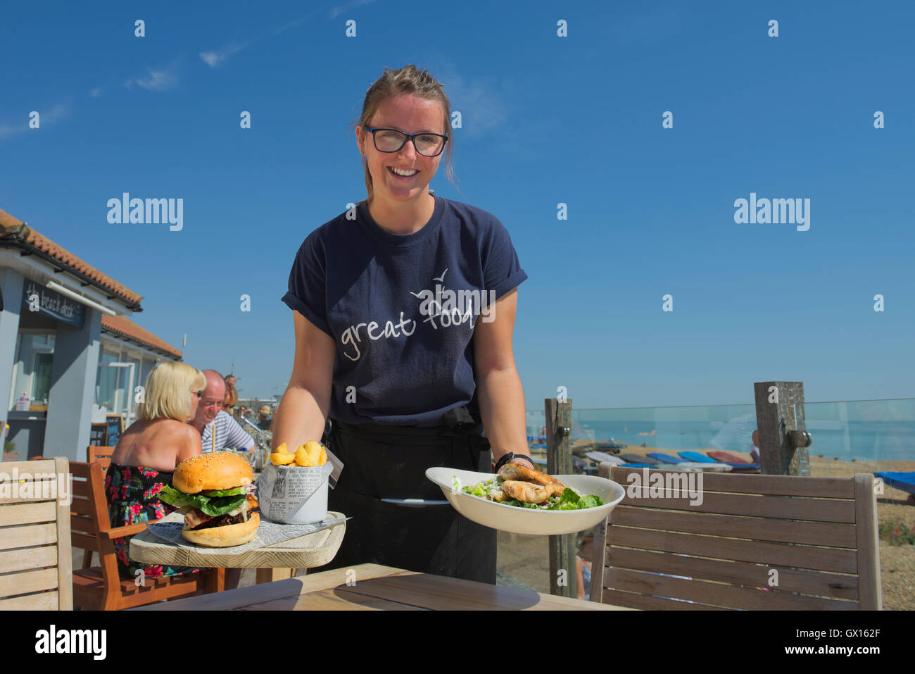 Waitress serving food at The Beach Deck. Eastbourne. Sussex. England ...
