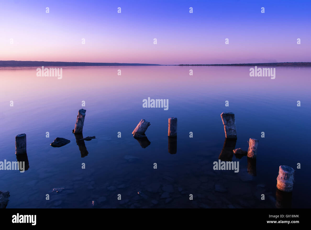 Colorful bright orange blue summer sunset over lake Stock Photo - Alamy