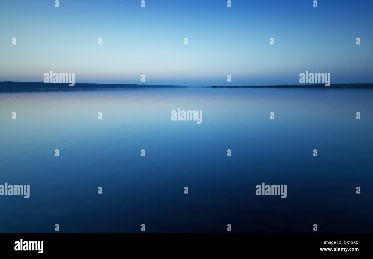 Colorful bright blue summer sunset over lake Stock Photo - Alamy