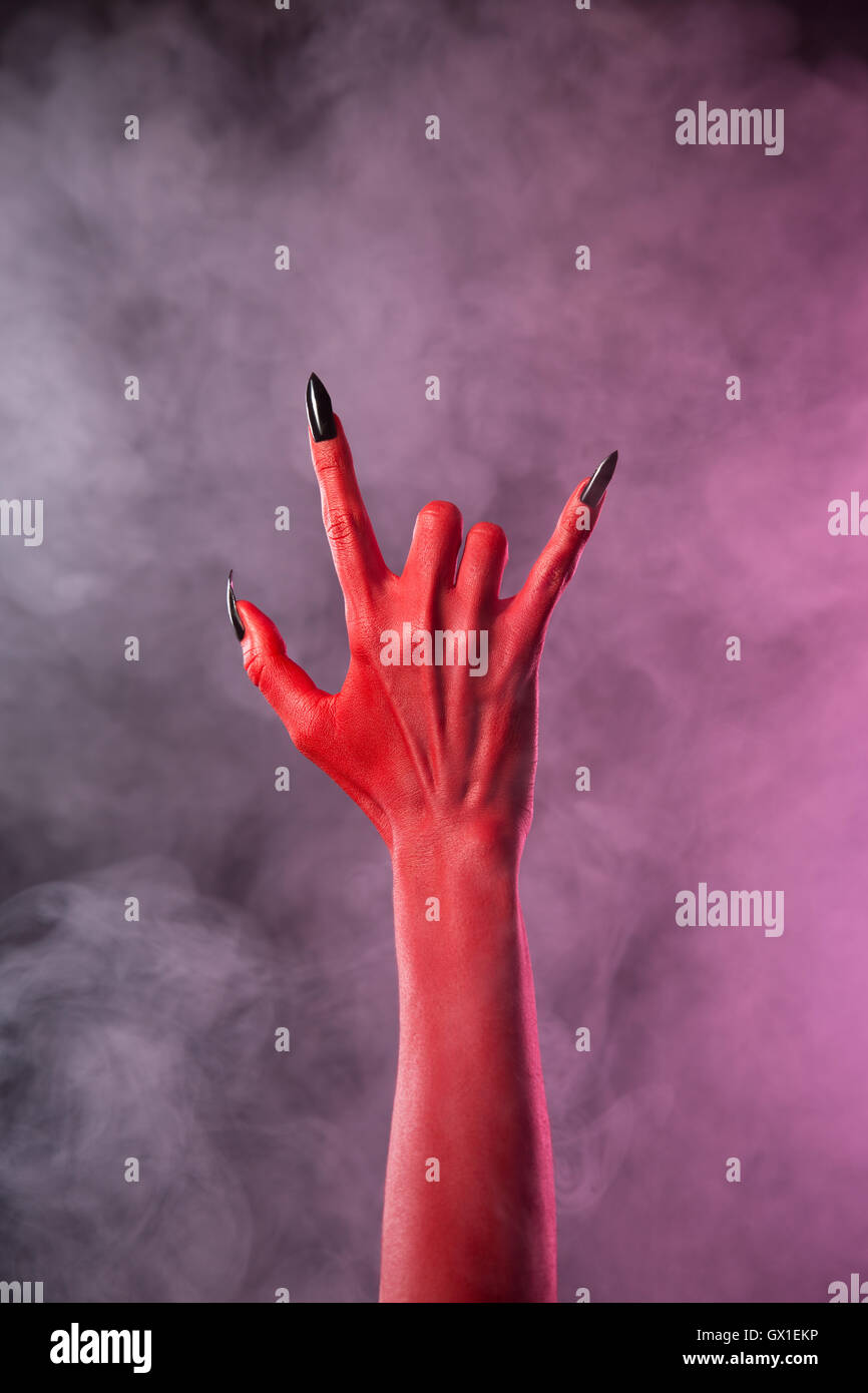 Spooky devil hand showing heavy metal gesture Stock Photo - Alamy