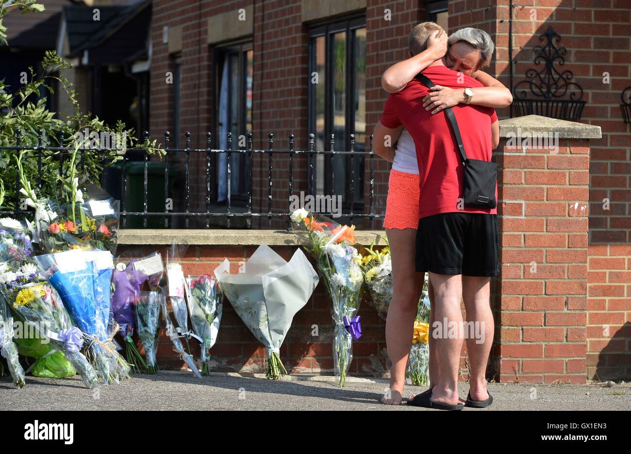 Perry Hayden (wearing in red) is comforted at the scene in Chadwell ...