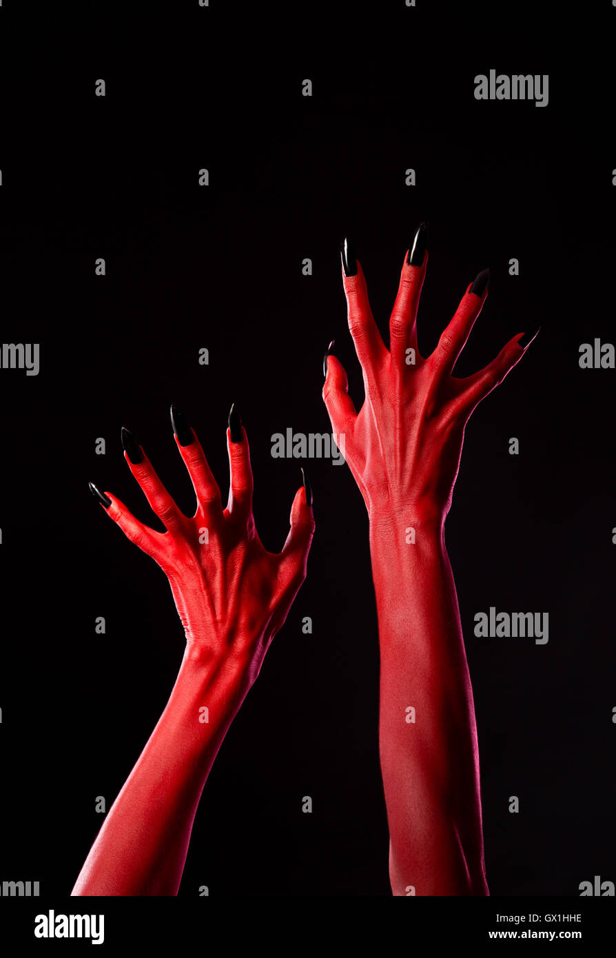 Spooky red demonic hands with black nails, real body-art Stock Photo ...