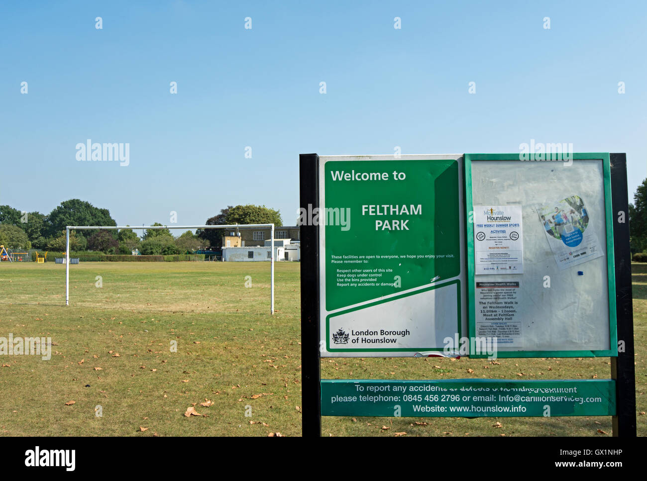 feltham park, with welcome notice and information board in foreground ...