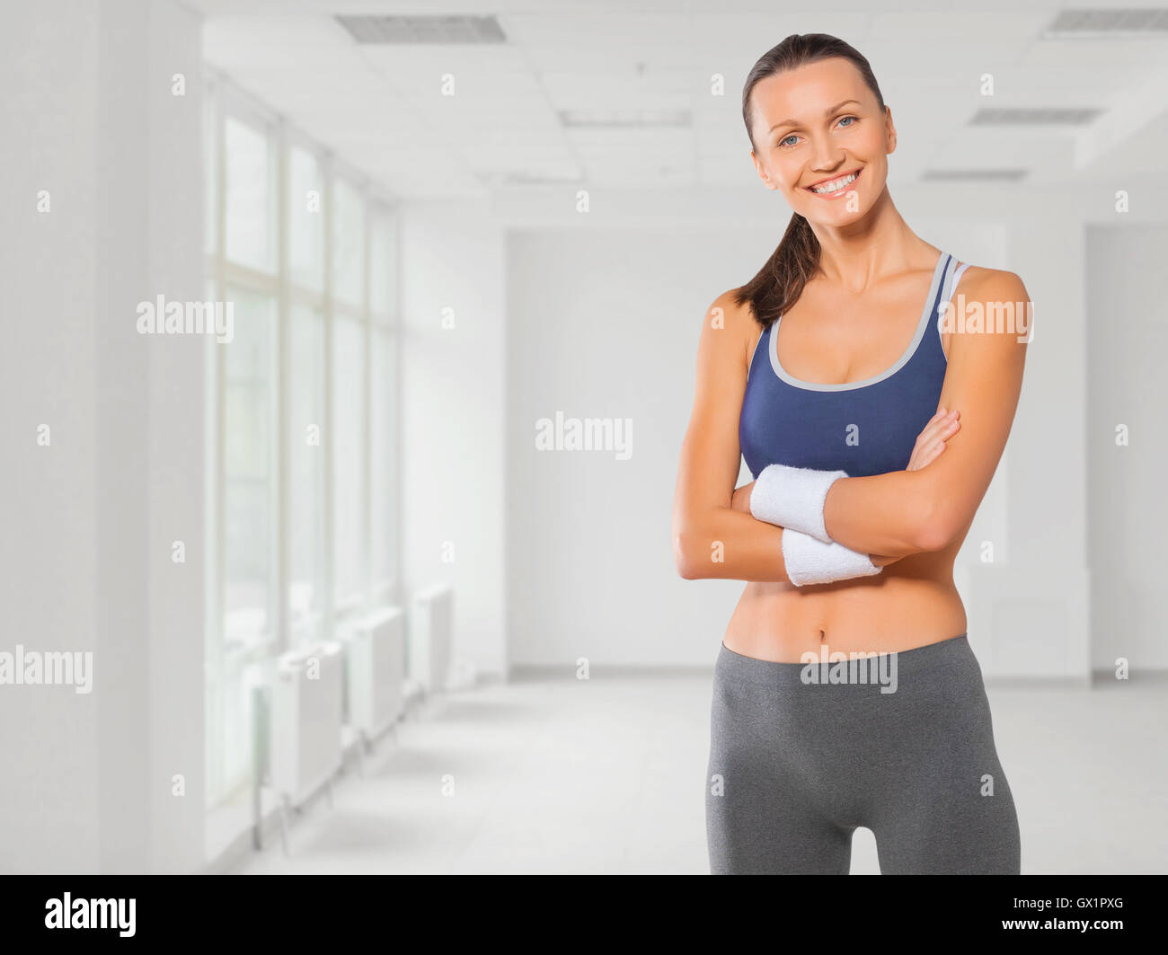 beautiful fitness girl smiling arms crossed Stock Photo - Alamy