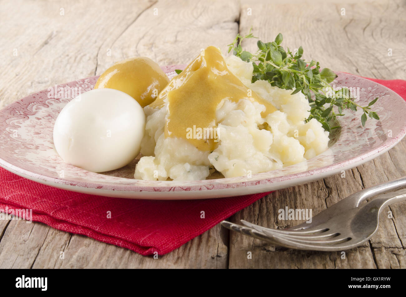 herb mashed potatoes with mustard eggs Stock Photo - Alamy
