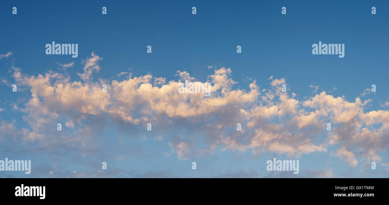 Early morning clouds at sunrise against a blue sky. UK Stock Photo - Alamy