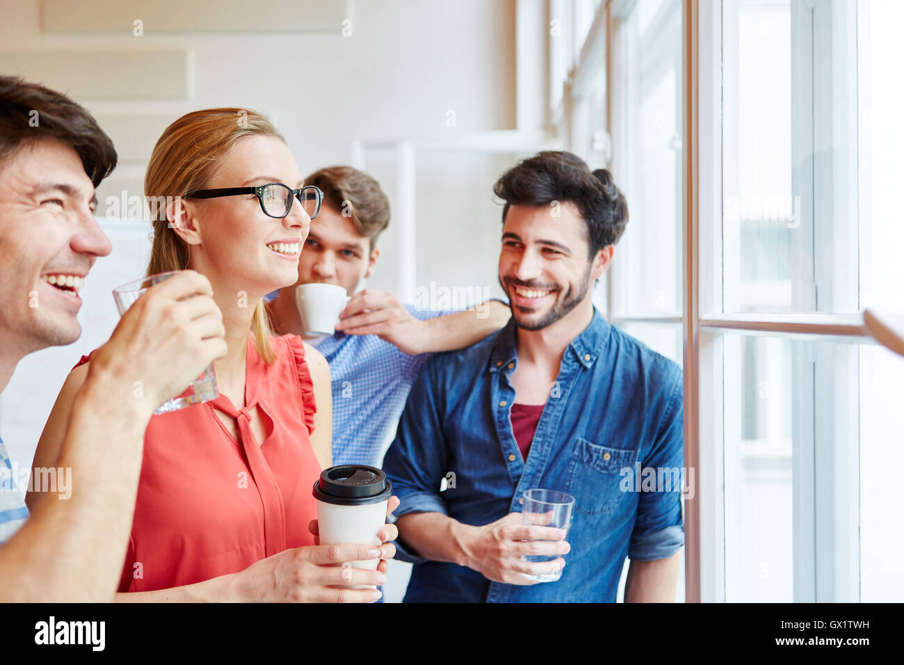 Successful start-up team taking a coffee break Stock Photo - Alamy
