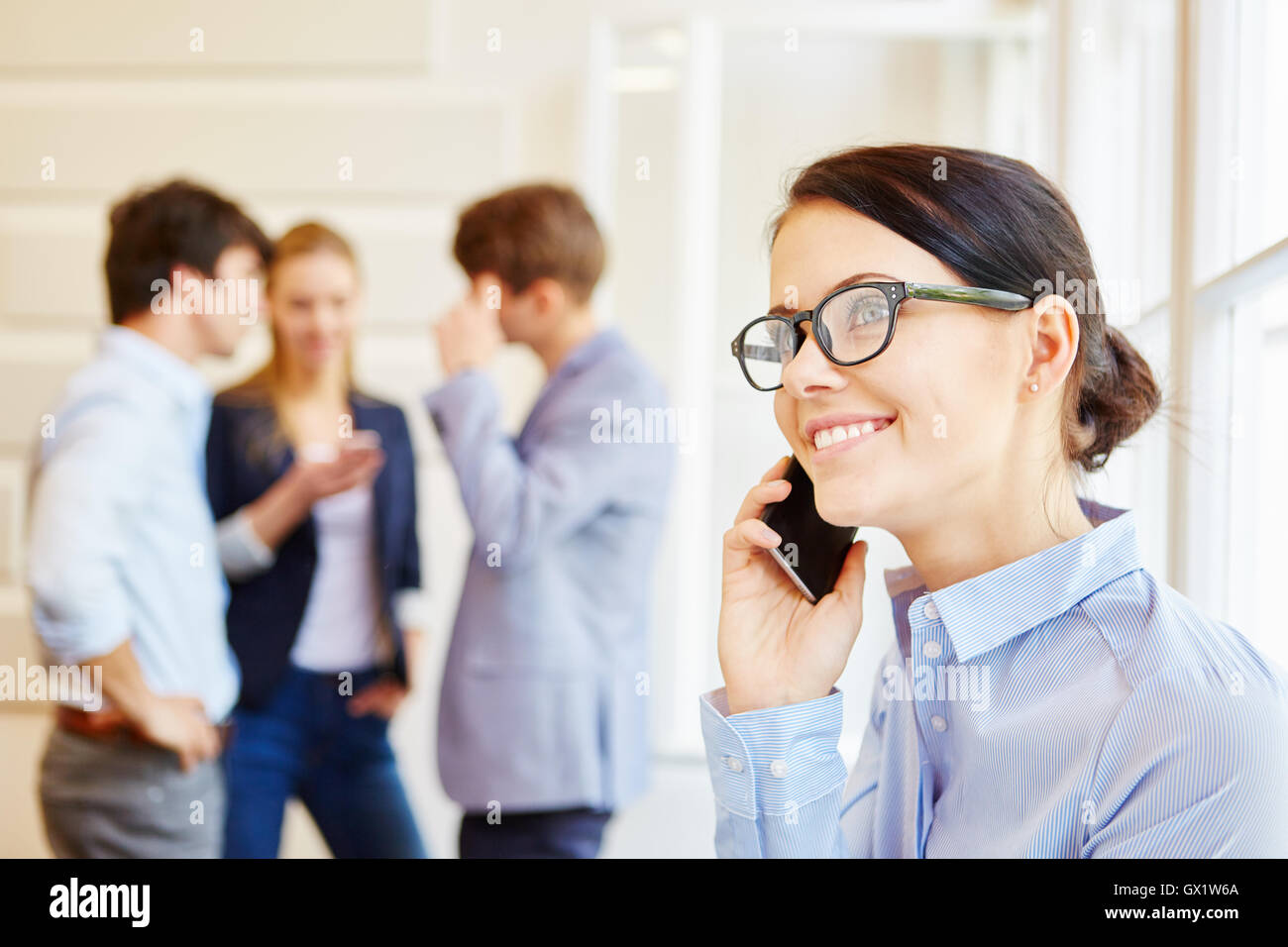 Woman calling with her phone communication good news Stock Photo - Alamy