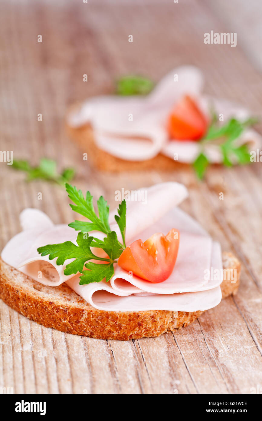 bread with sliced ham, fresh tomatoes and parsley Stock Photo - Alamy