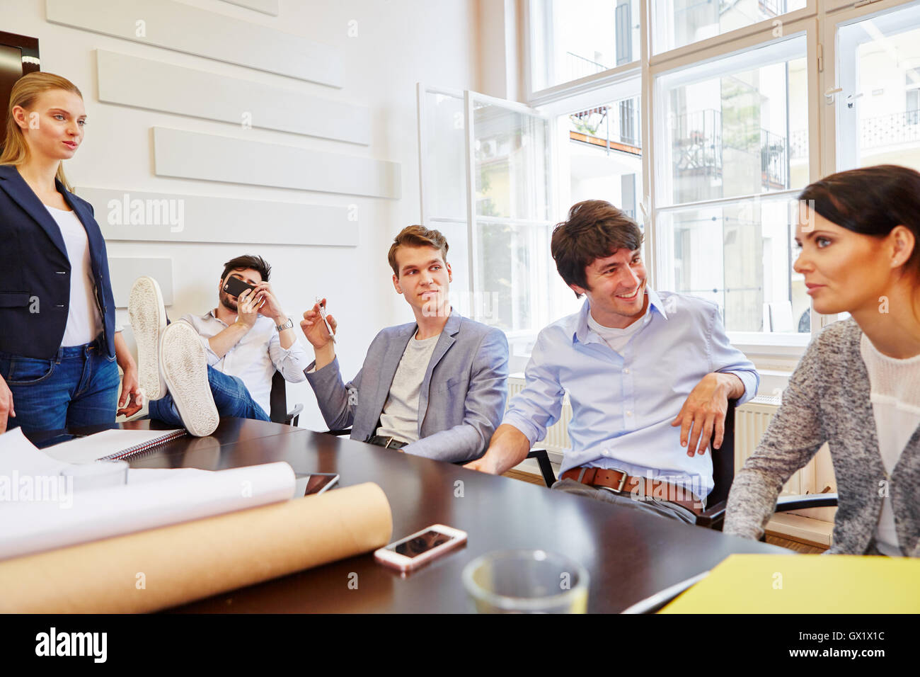 Team in their meeting break relaxing with colleagues Stock Photo - Alamy