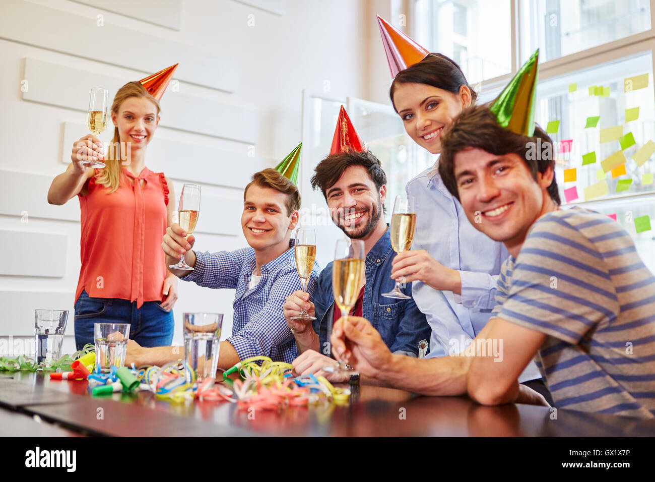 Proud group of friends as students celebrating success with champagne ...
