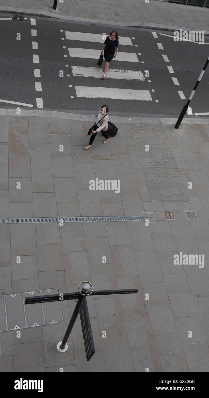 London signpost with pedestrians crossing a zebra crossing Stock Photo ...
