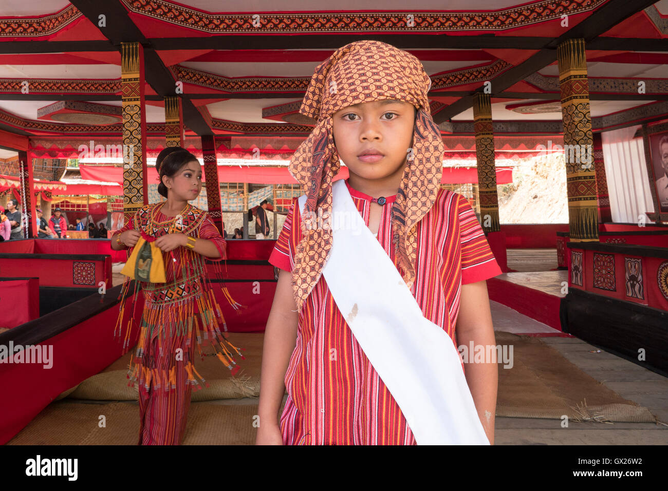Portrait of two young Torajan pose for camera with traditional costume ...