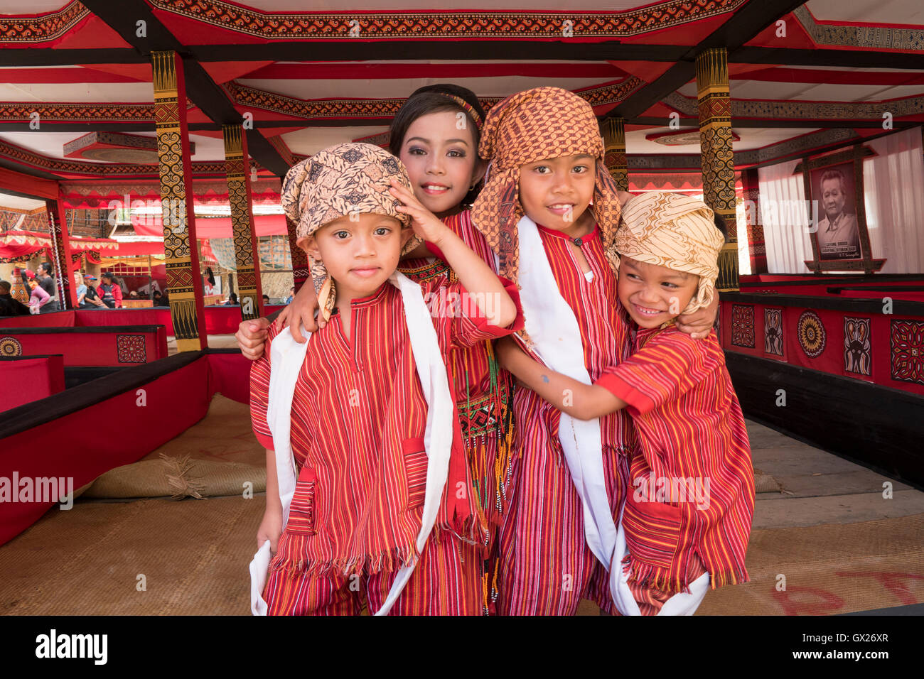Portrait of two young Torajan pose for camera with traditional costume ...