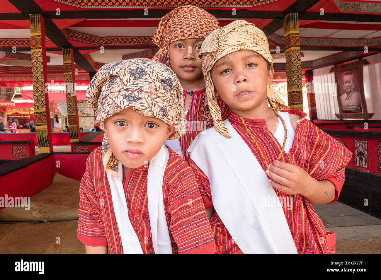Portrait of two young Torajan pose for camera with traditional costume ...