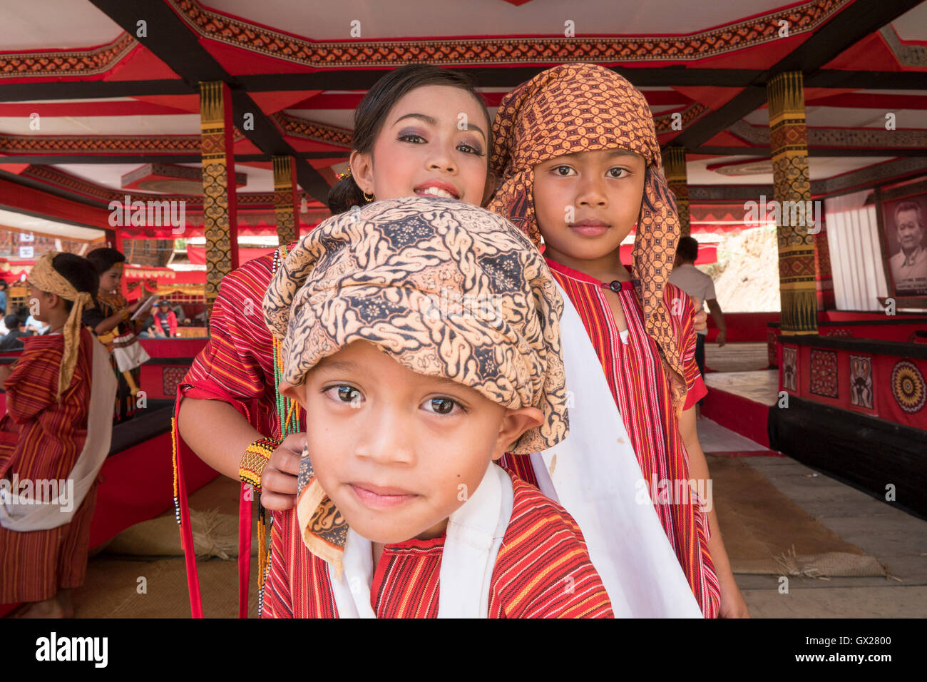 Portrait of two young Torajan pose for camera with traditional costume ...