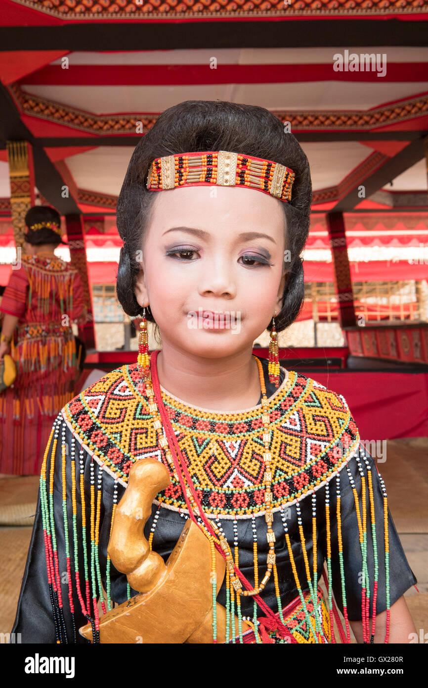 Portrait of two young Torajan pose for camera with traditional costume ...