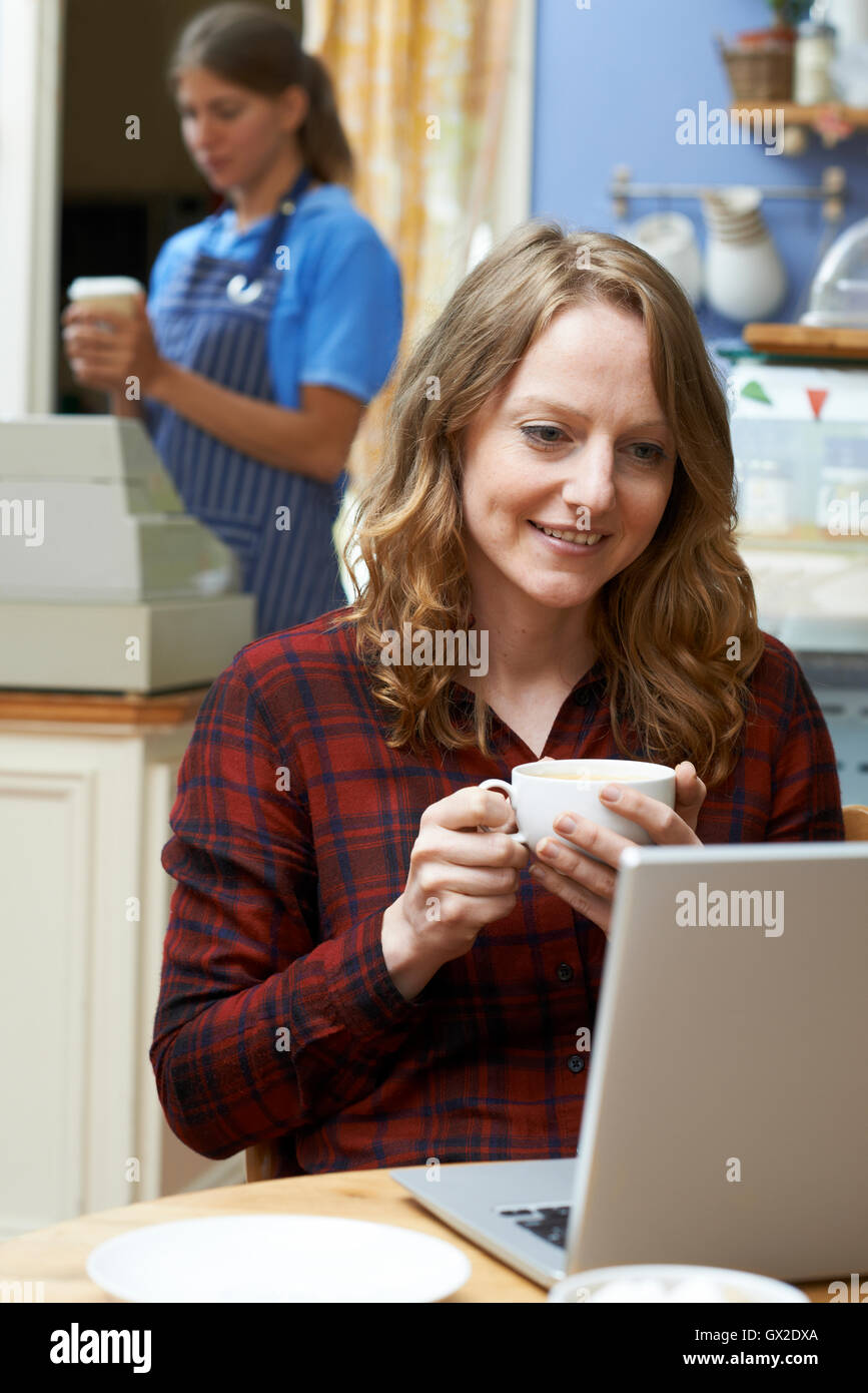 Woman In Coffee Shop Using Laptop Computer Stock Photo - Alamy