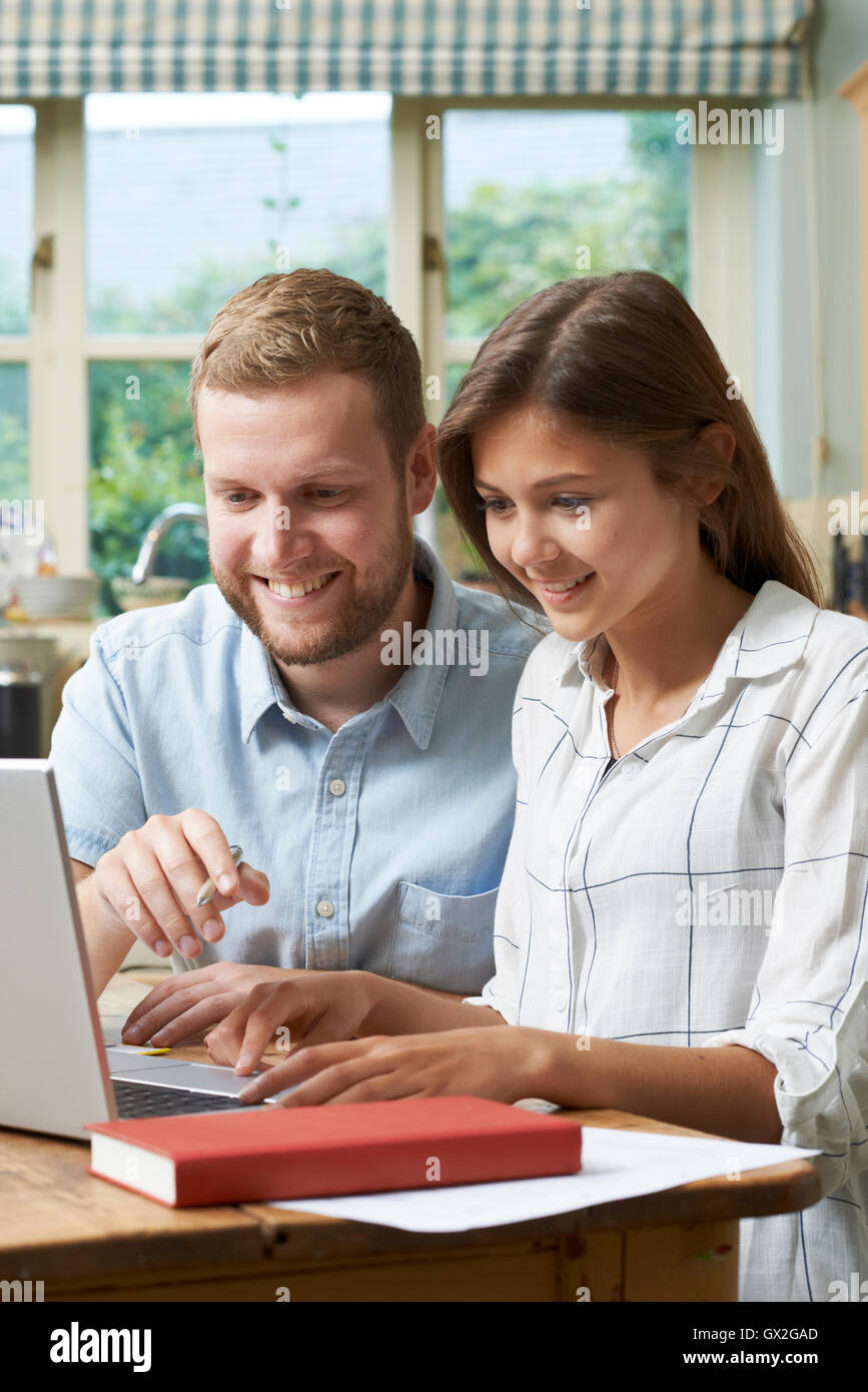 Male Home Tutor Helping Teenage Girl With Studies Stock Photo - Alamy