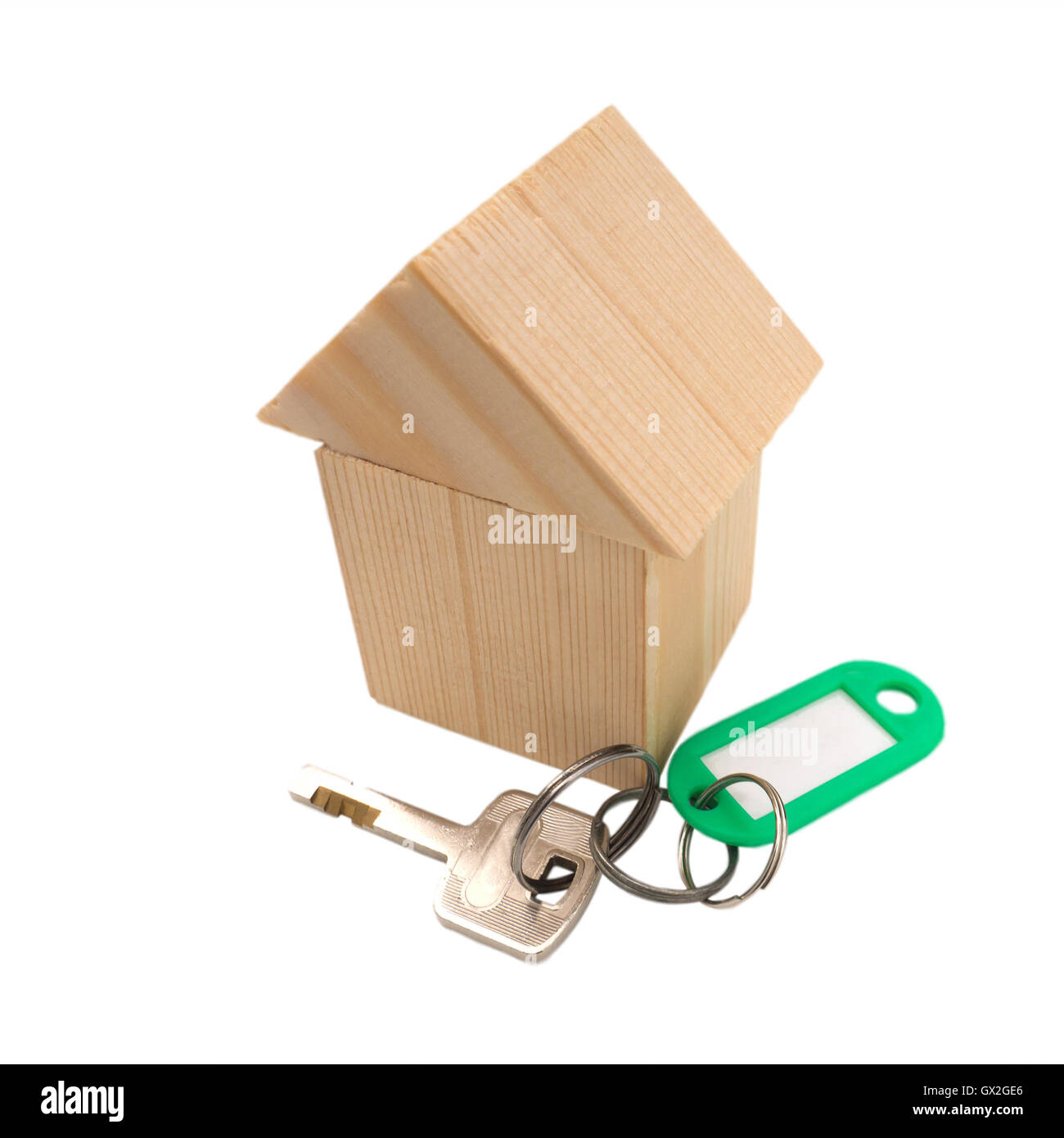 Wooden building blocks home and a key with green label isolated on ...
