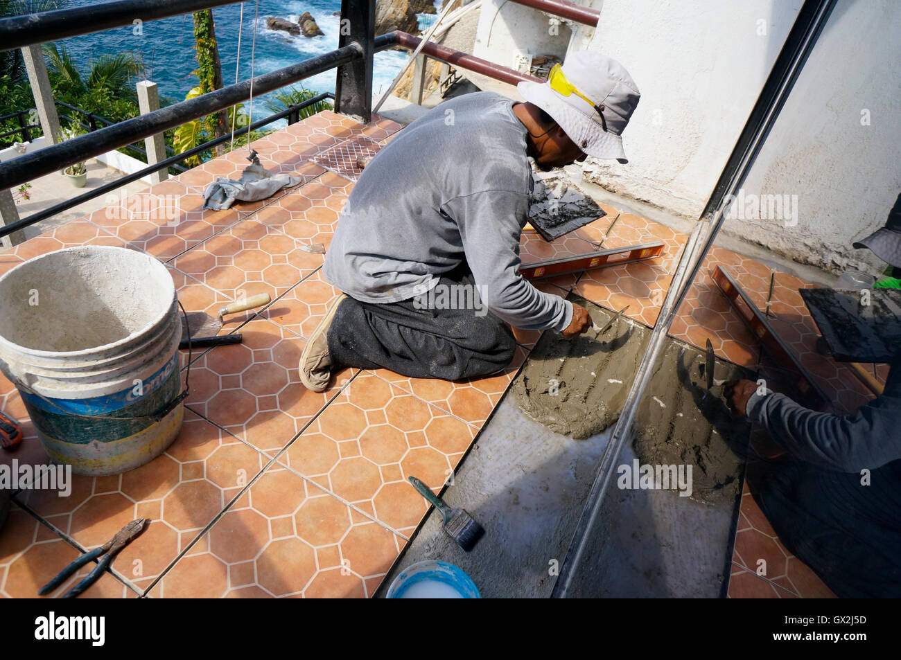 Mexican man laying tile in Acapulco, Mexico Stock Photo - Alamy