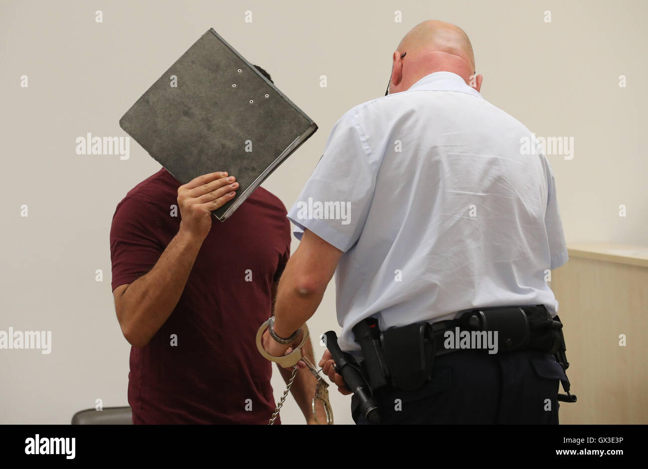 Gera, Germany. 15th Sep, 2016. The main defendant hides his face behind ...