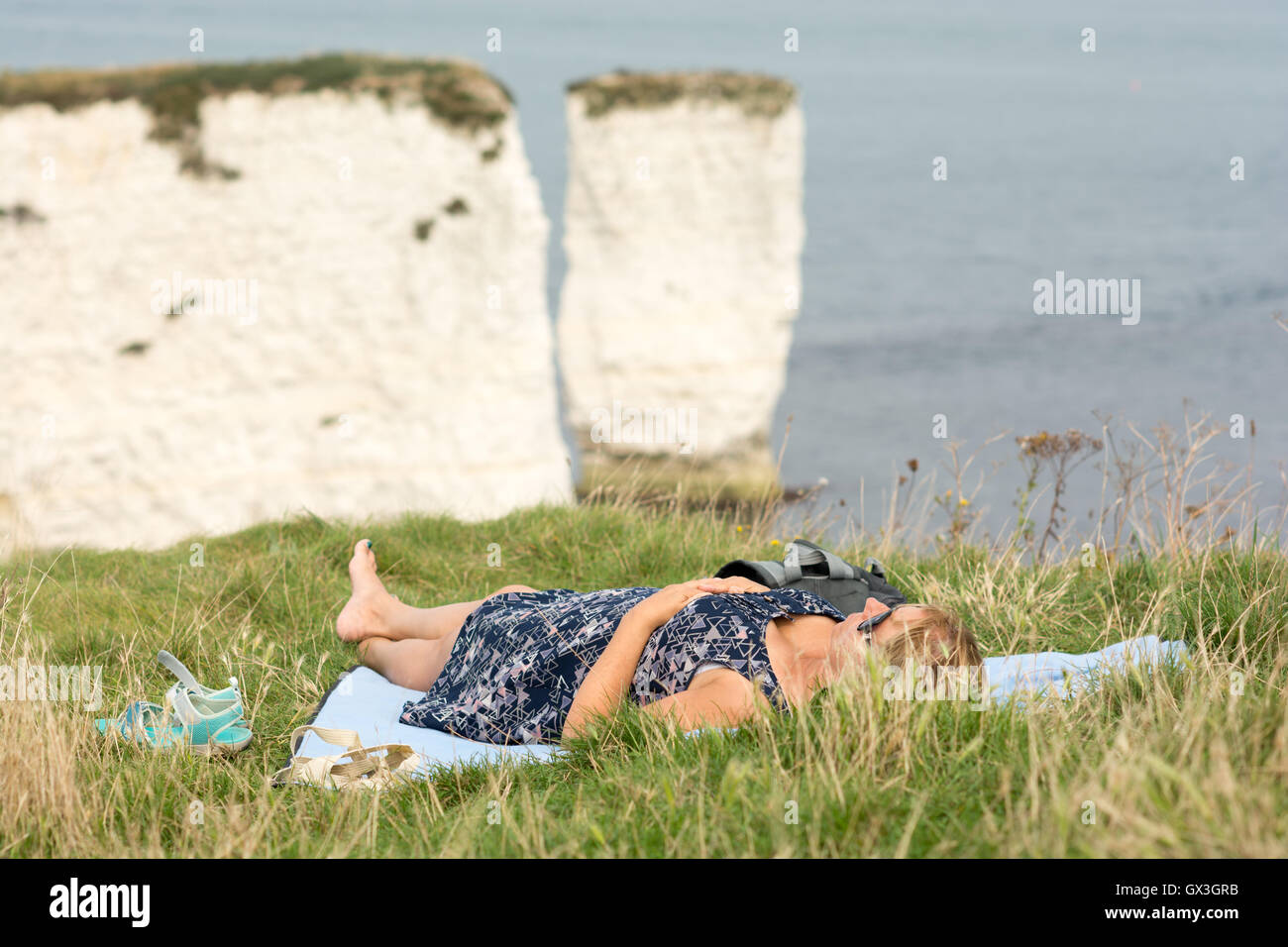 Woman sleeping on rocks hi-res stock photography and images - Alamy
