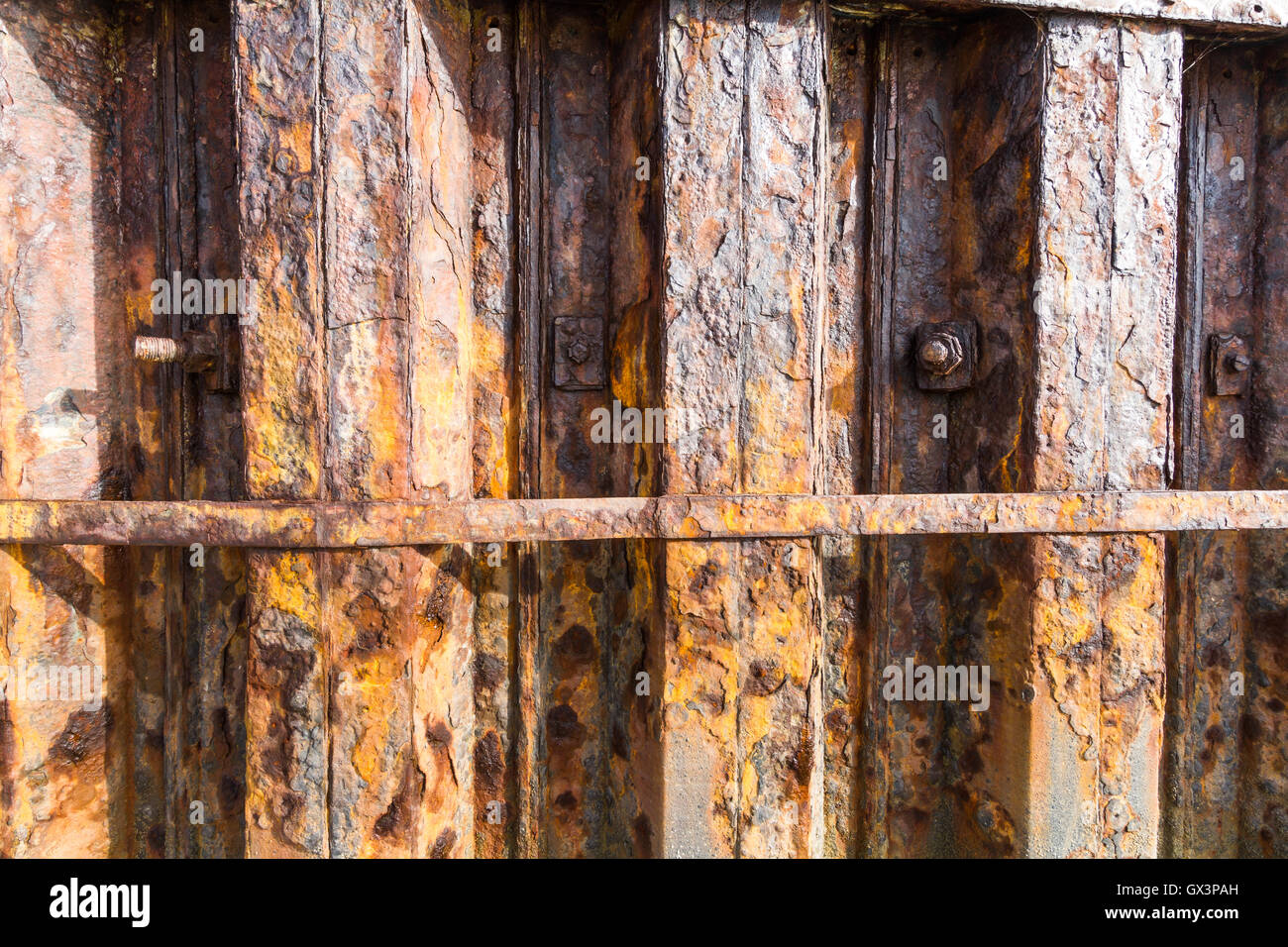 Rusting iron interlocked girders that form part of harbour harbour wall ...