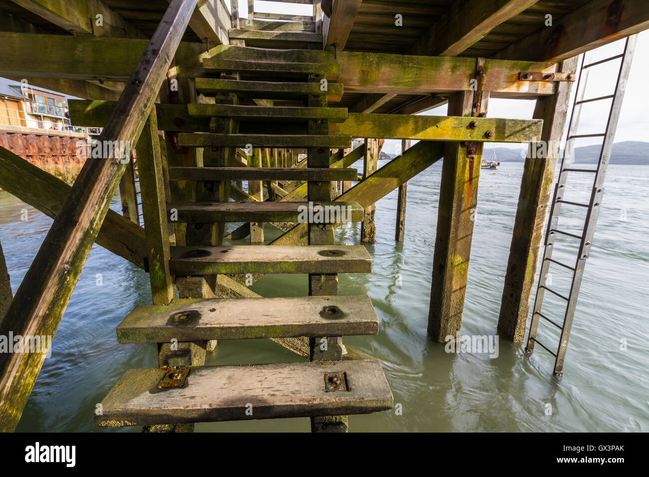 Wooden steps leading to platform below jetty Stock Photo - Alamy