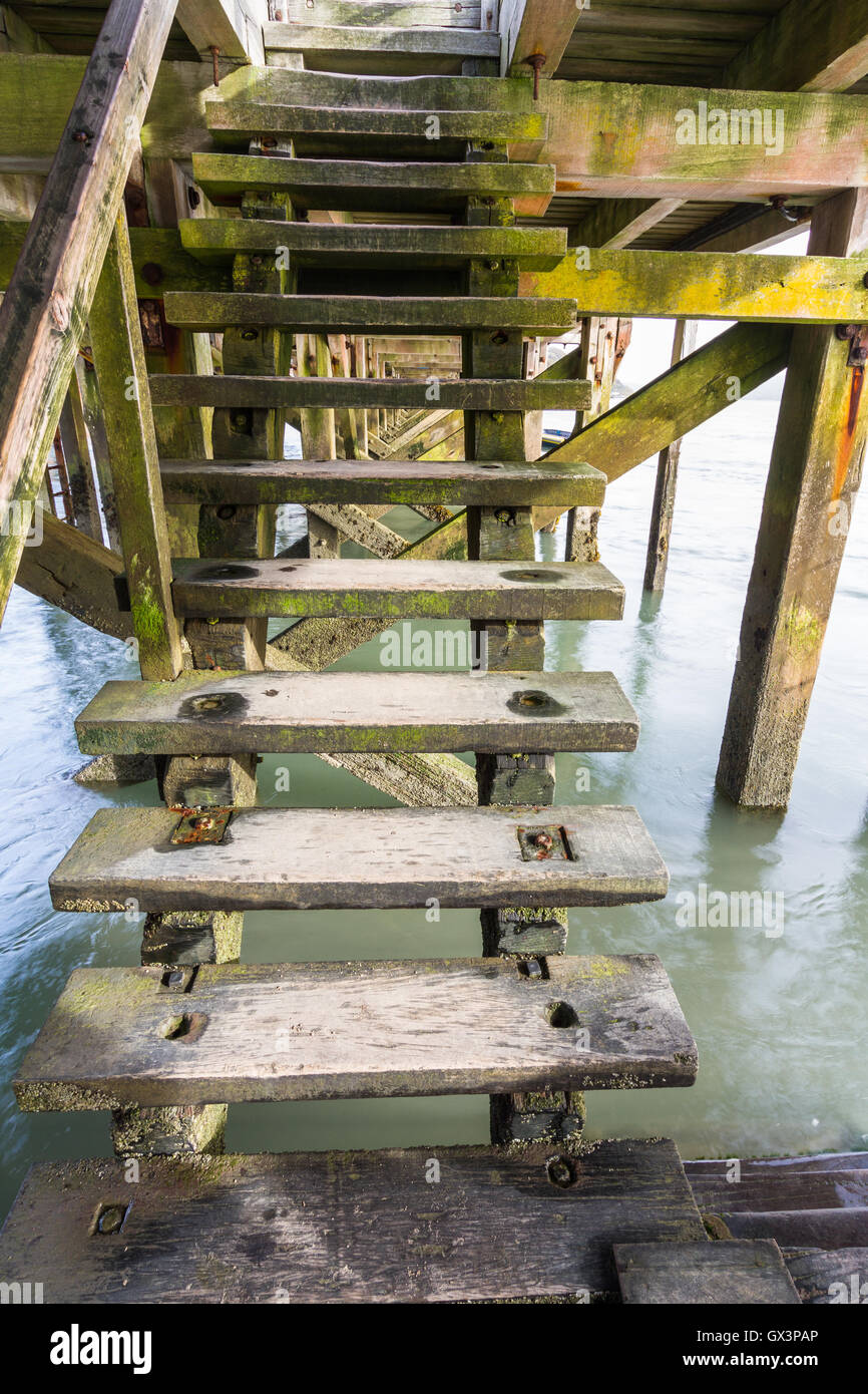 Wooden steps leading to platform below jetty Stock Photo - Alamy