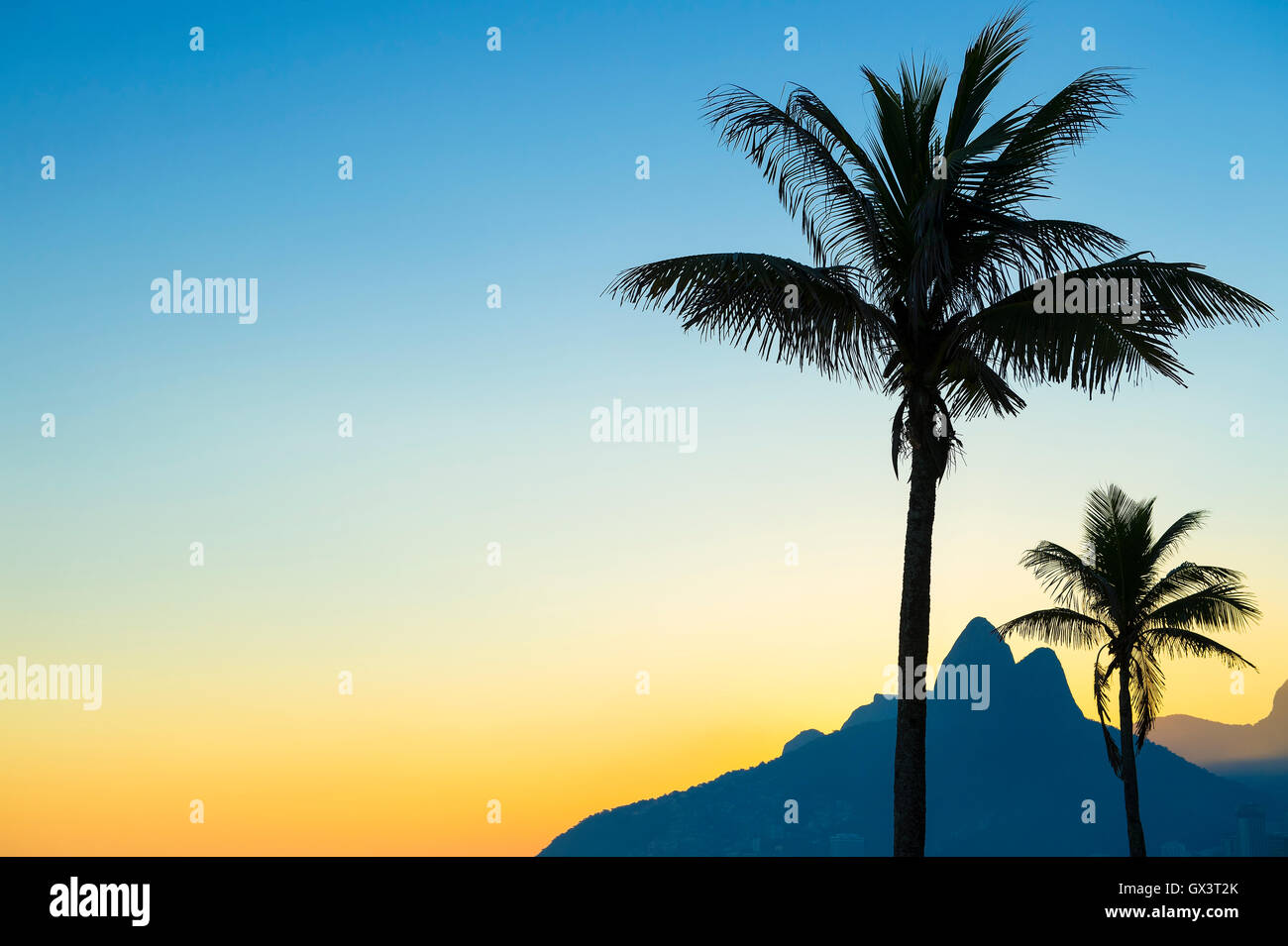 Sunset on Ipanema Beach with Two Brothers Mountain and palm tree ...