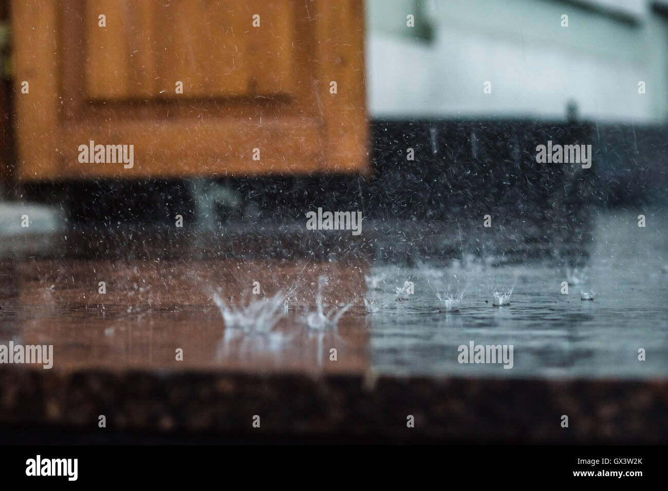 heavy rain drops falling on city asphalt during downpour Stock Photo ...