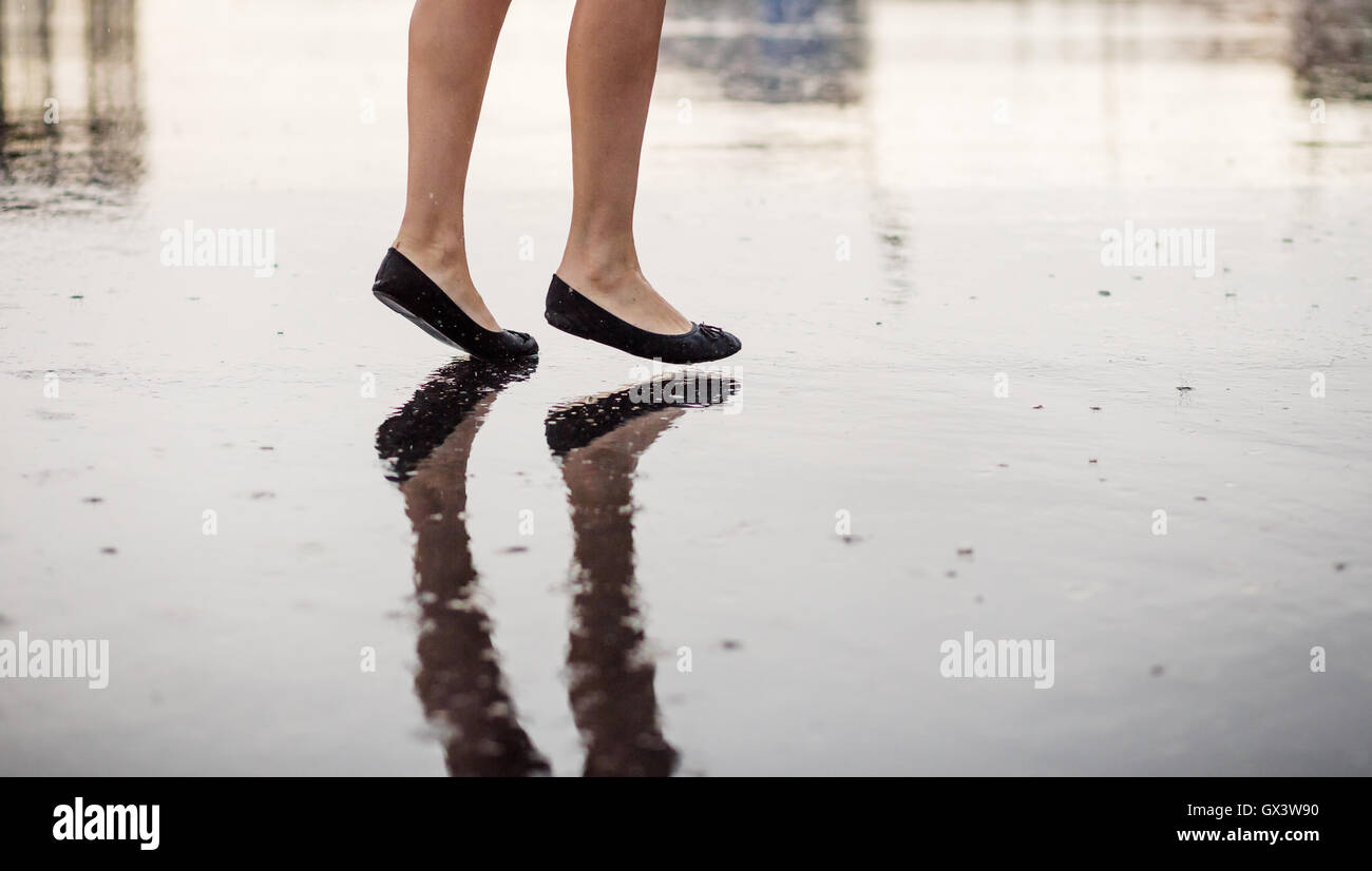 Woman legs and rain drops on asphalt Stock Photo - Alamy