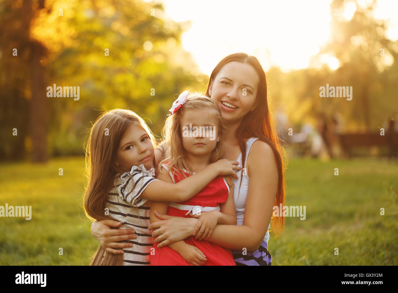 Family hug. Mother and two daughters together. On open air Stock Photo ...