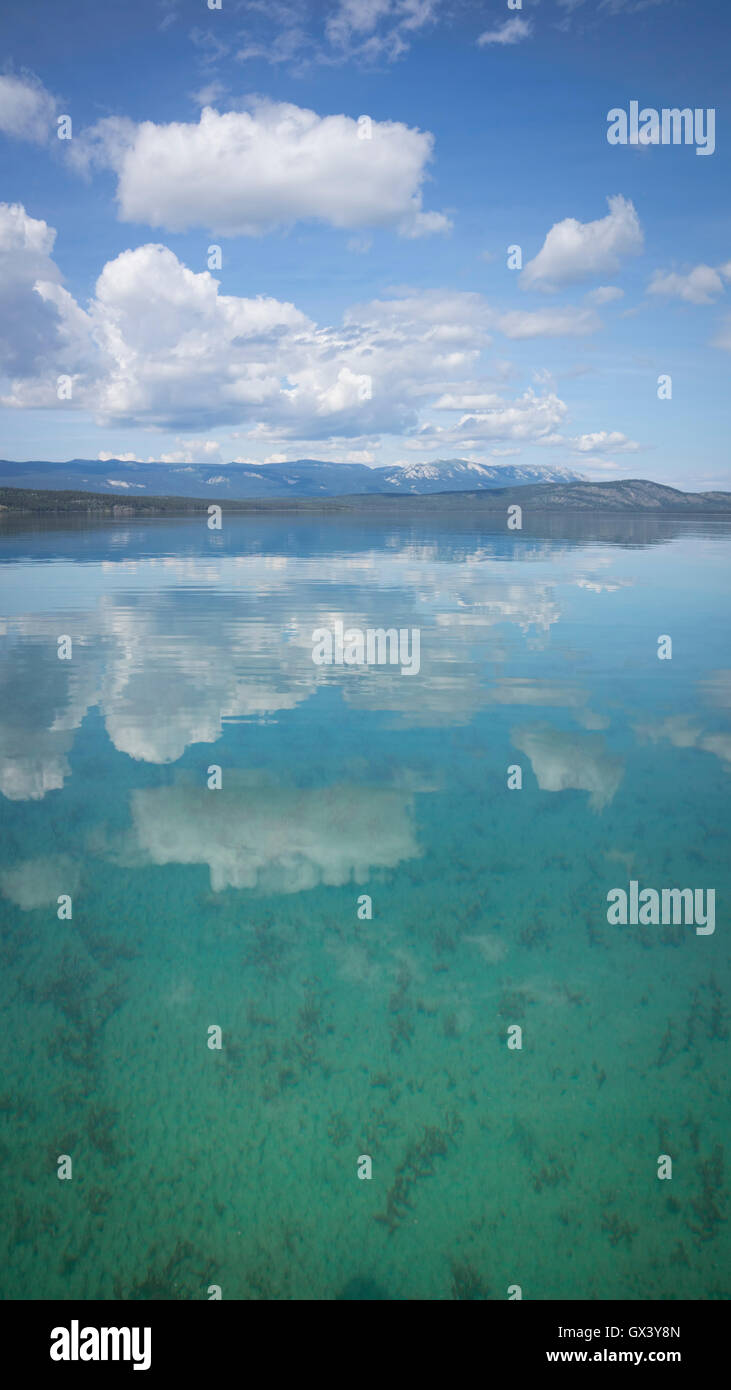 Atlin Lake in Canada with clear water and cloud reflections in summer ...