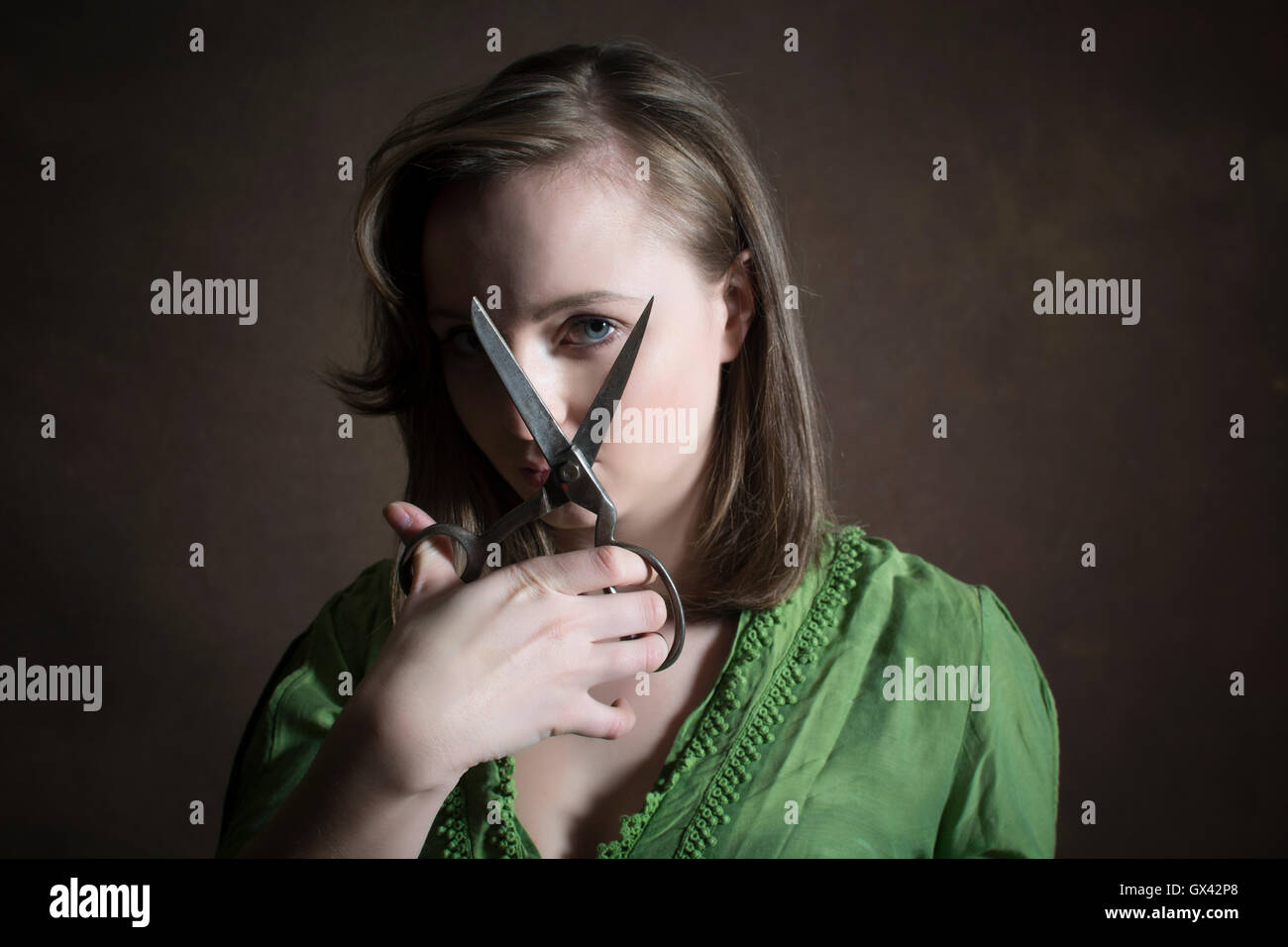 Hand holding scissors moody hi-res stock photography and images - Alamy