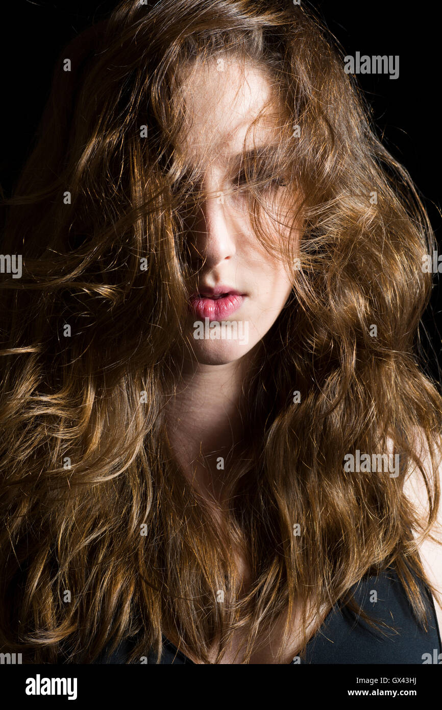 Young woman covering face hair beautiful woman hi-res stock photography ...