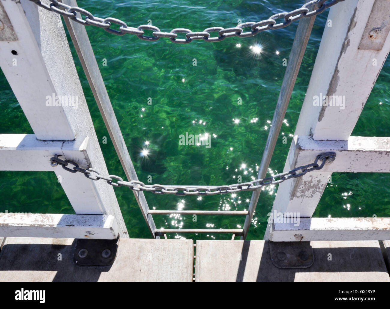 White wooden jetty structure with draped chain link fronting descending ...