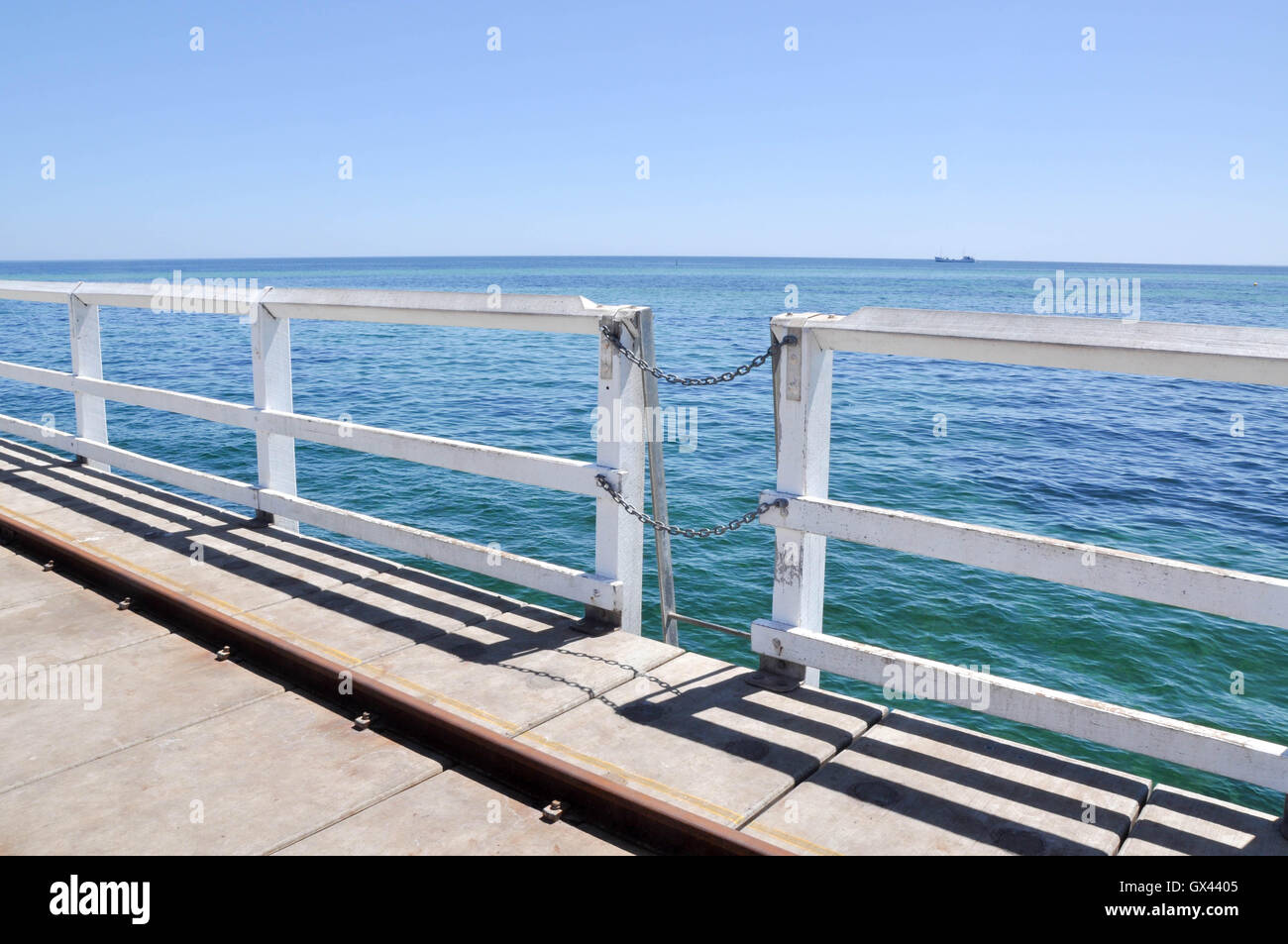 White Busselton Jetty railing with chain link at exit ladder with ...