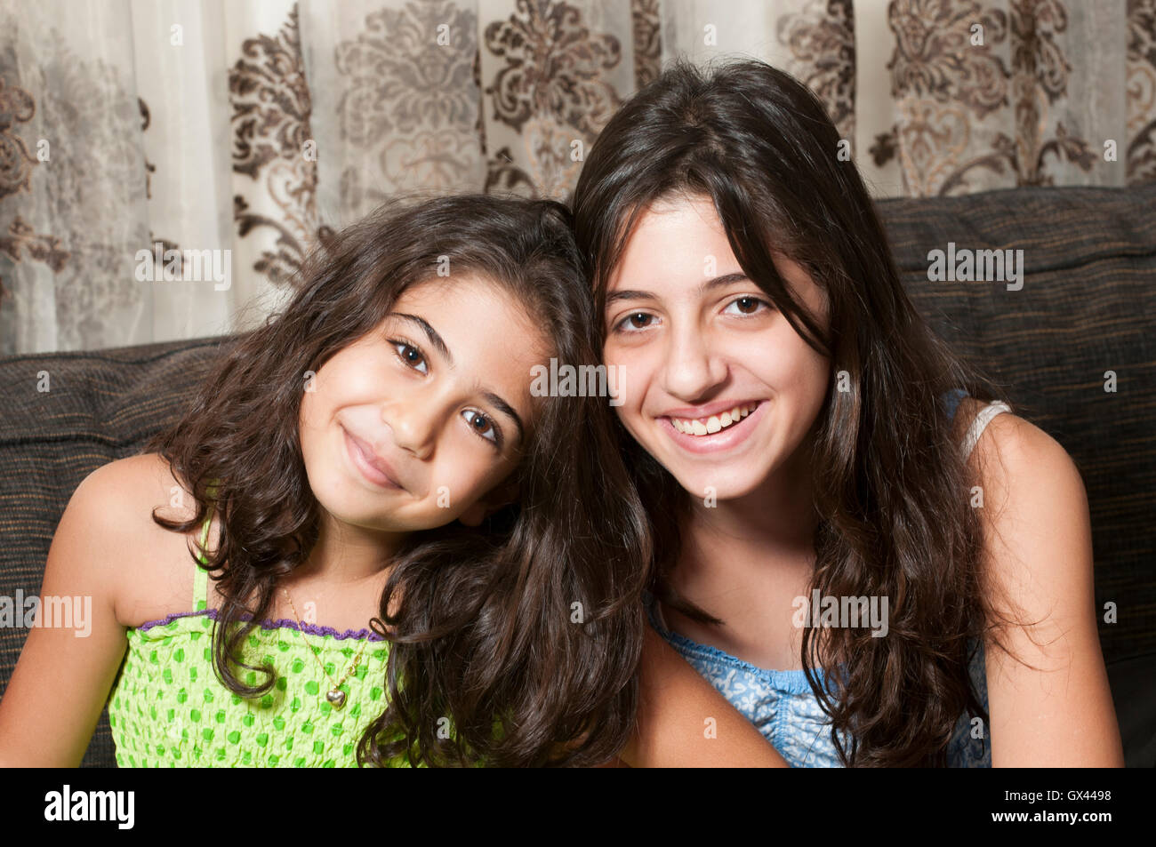 Happy sisters smiling Stock Photo - Alamy