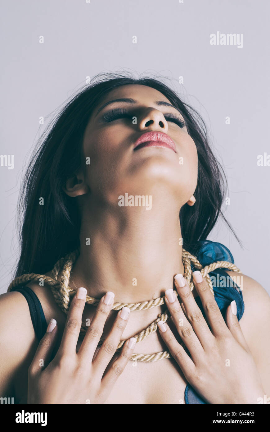 Suffering woman with rope around her neck Stock Photo - Alamy