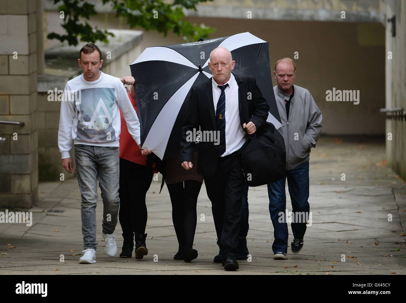 Claire Riley, 23, (behind umbrella) arrives at Northampton Crown Court ...