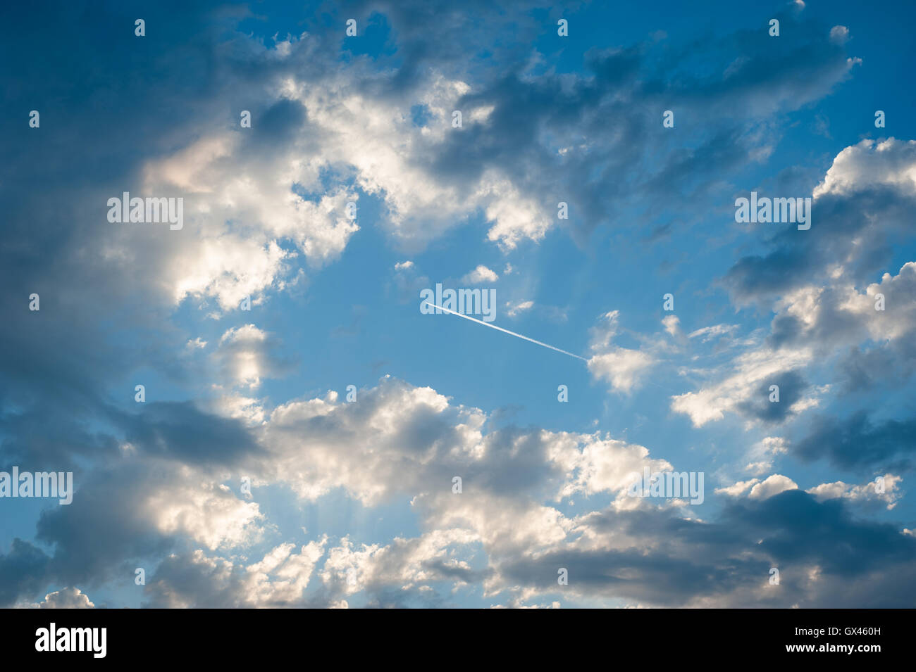 Contrails or vapour trails behind a aircraft as it flies in-between ...