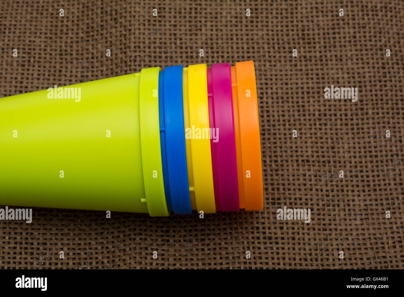 plastic multi-colored glasses isolated on dark background. Glass of ...